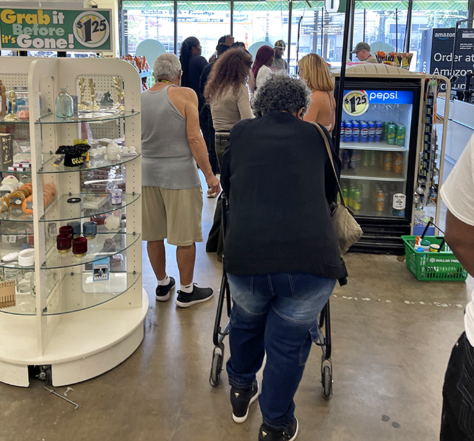 A diverse crowd of savvy shoppers navigates the checkout area, united in the universal quest for stretching dollars further than physics should allow.