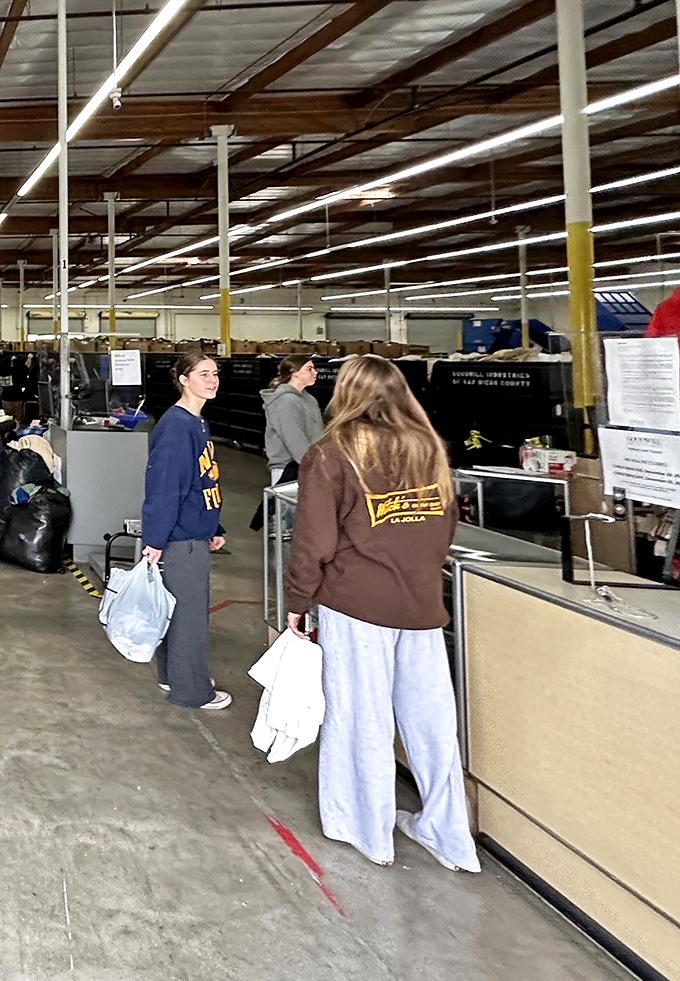 Early birds strategically position themselves for the next bin rotation, armed with determination and sturdy shopping bags.