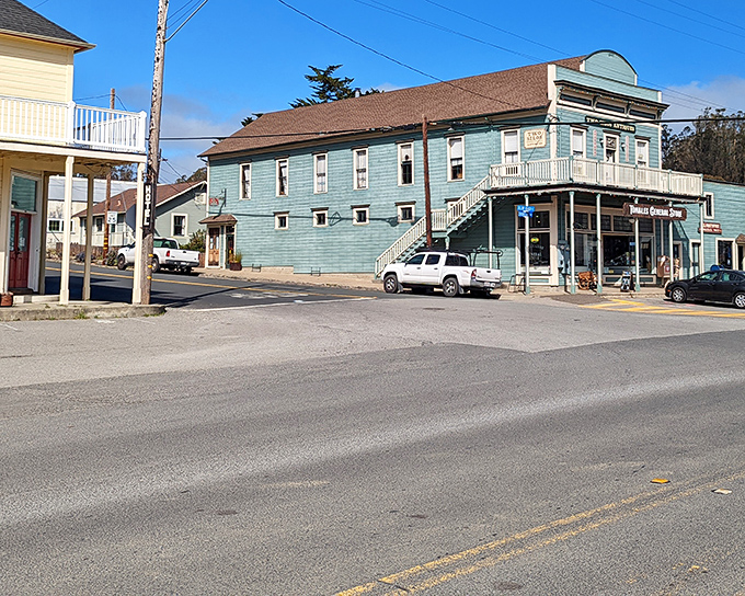 The William Tell House stands sentinel at the corner, its turquoise facade a beacon for hungry travelers and thirsty locals since the 1870s.