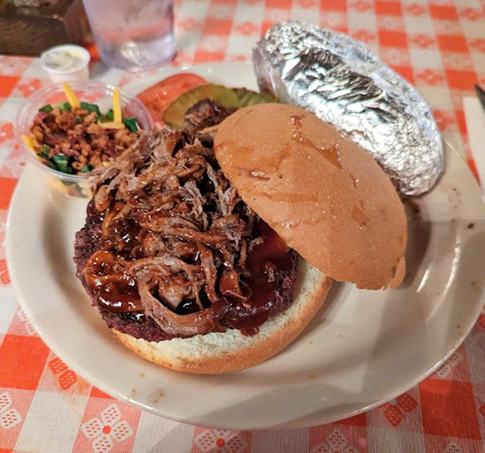 The shredded pit beef sandwich arrives like a delicious avalanche on a bun, with crispy onions adding the perfect textural counterpoint.
