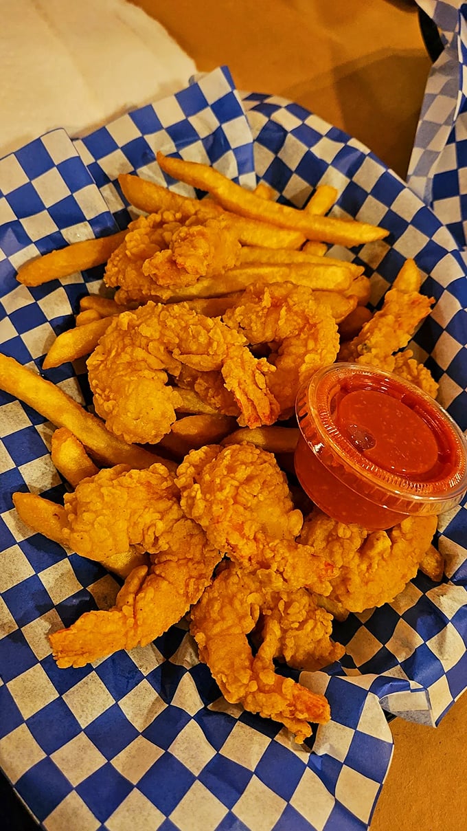 Golden-fried shrimp nestled among crispy fries &ndash; proof that sometimes the simplest pleasures are the most satisfying.