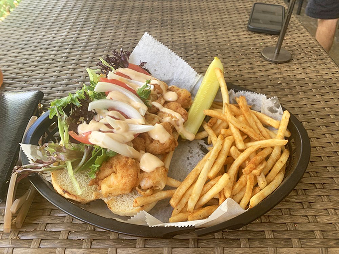 This isn't just a sandwich; it's seafood architecture &ndash; crispy shrimp stacked with fresh veggies and sauce that demands both napkins and respect.