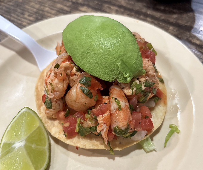 This shrimp taco isn't just food, it's architecture – a perfect balance of seafood, salsa, and that crowning touch of avocado.