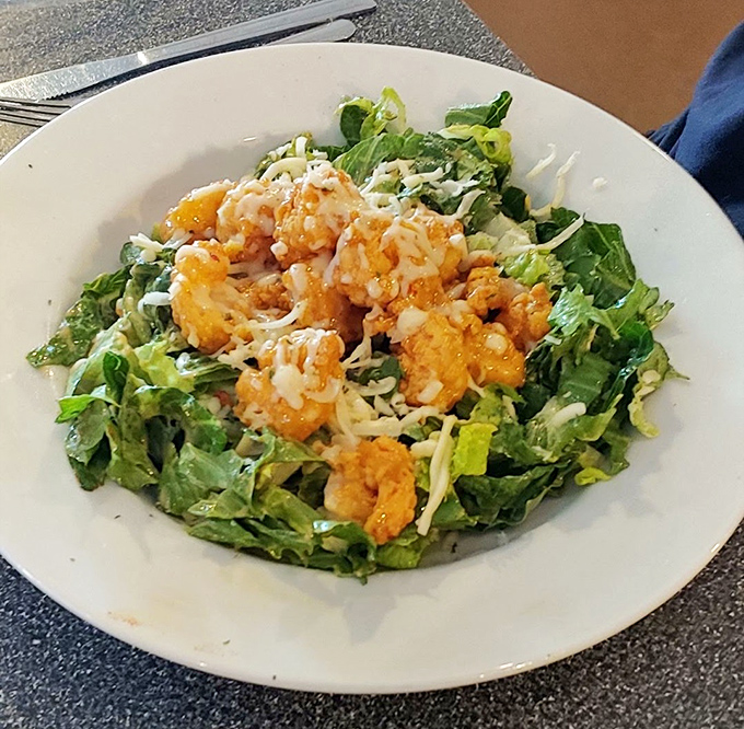 Crispy golden shrimp perched atop fresh greens—a salad that makes you forget you're eating something healthy. Virtue never tasted so indulgent.