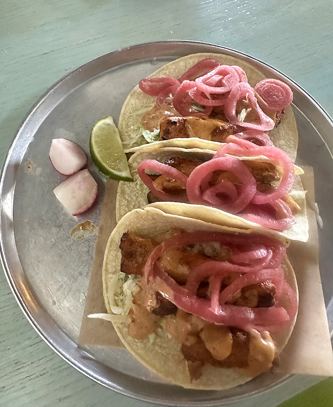 Fish tacos topped with vibrant pink pickled onions&mdash;proof that sometimes the most beautiful things in life come on corn tortillas.