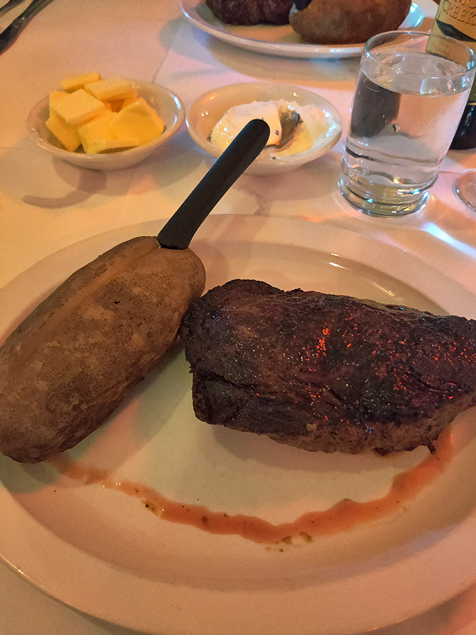 Simplicity perfected: a sirloin with the kind of char that whispers sweet nothings to your taste buds while that baked potato stands by, ready for action.