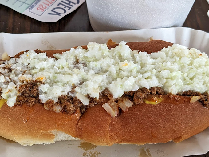 The legendary slaw dog in all its glory: chili, onions, and that perfect heap of homemade slaw creating a harmony that Mozart would envy.