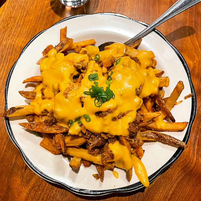 Cheese-covered fries that make sharing impossible. Like a savory sundae for grown-ups, these loaded potatoes demand your complete attention.