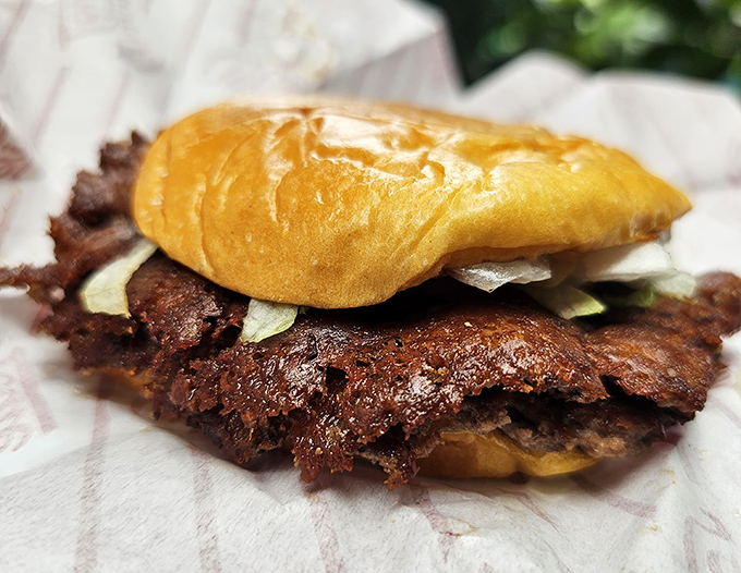 The smash technique creates that coveted crust while keeping the inside juicy. It's like the mullet of burgers – business on the outside, party inside.