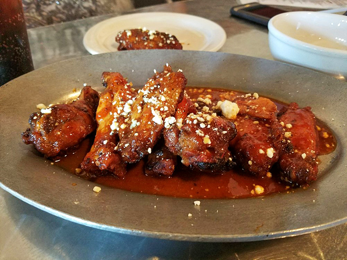 These aren't just wings; they're flavor bombs with a PhD in deliciousness. The sauce glistens with promise, the crumbled cheese adds the perfect finish.