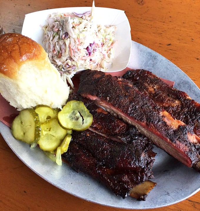 Ribs with that perfect smoke ring, coleslaw that actually matters, and pickles that aren't an afterthought&mdash;this is barbecue that respects tradition.