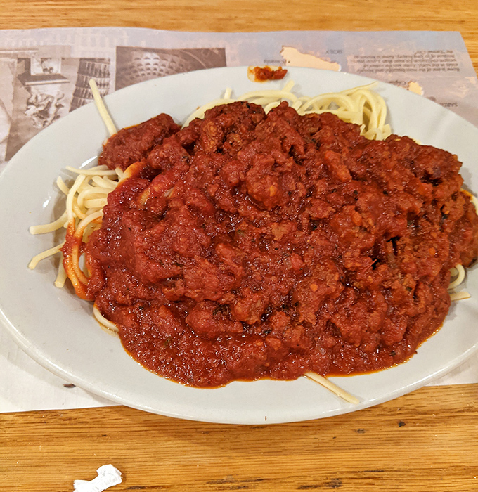 Spaghetti with meat sauce so generous it threatens to overtake the plate. This isn't a meal; it's a declaration that portion control is for another day.