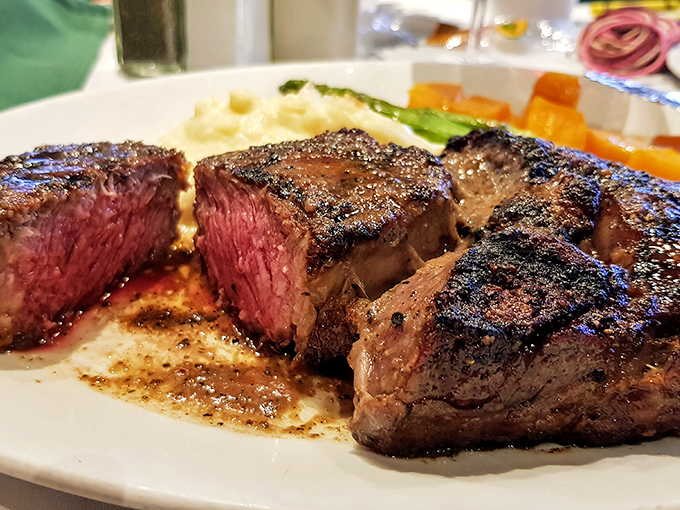 The perfect medium-rare: A beautifully crusted steak reveals its ruby interior, glistening with juices that carry flavor straight to your soul.