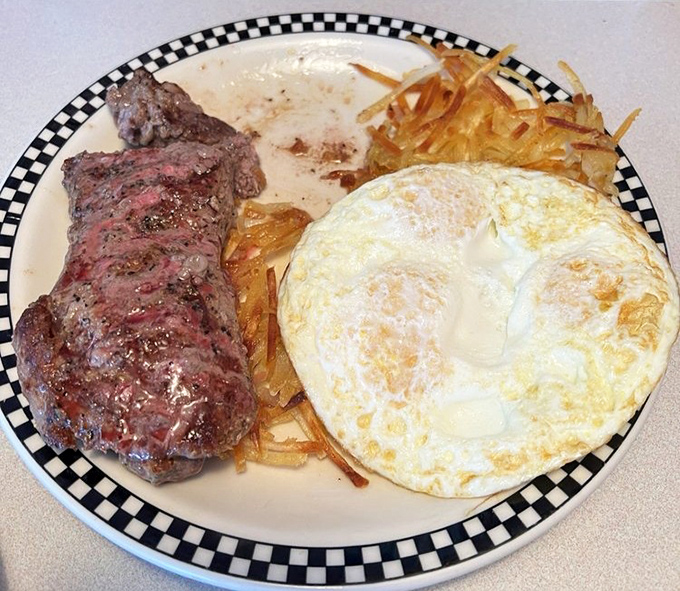 When your steak and eggs arrive on a plate with that checkered rim, you know you're about to experience breakfast the way your grandparents did—gloriously unfiltered.