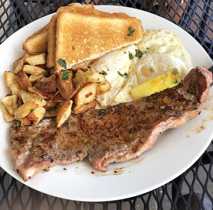 When breakfast means business: a perfectly seared steak alongside golden home fries and eggs with yolks as sunrise-orange as a Florida morning.