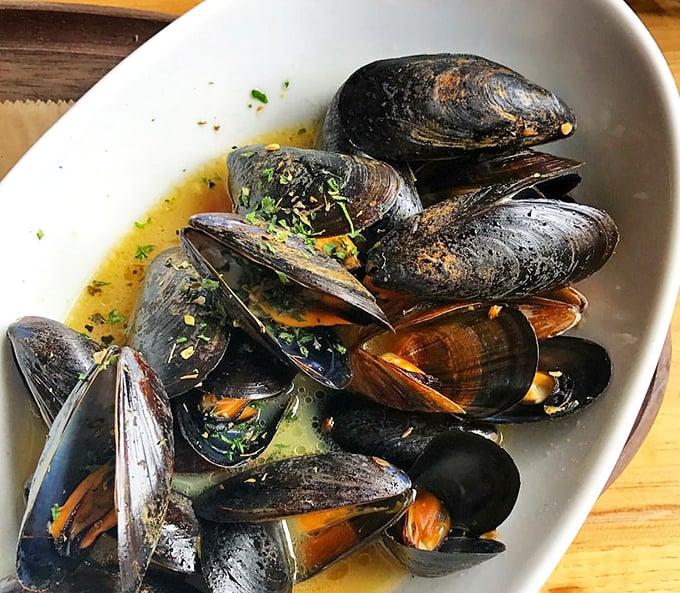 These mussels aren't just steamed; they're having a spa day in white wine broth that you'll want to bottle and take home.