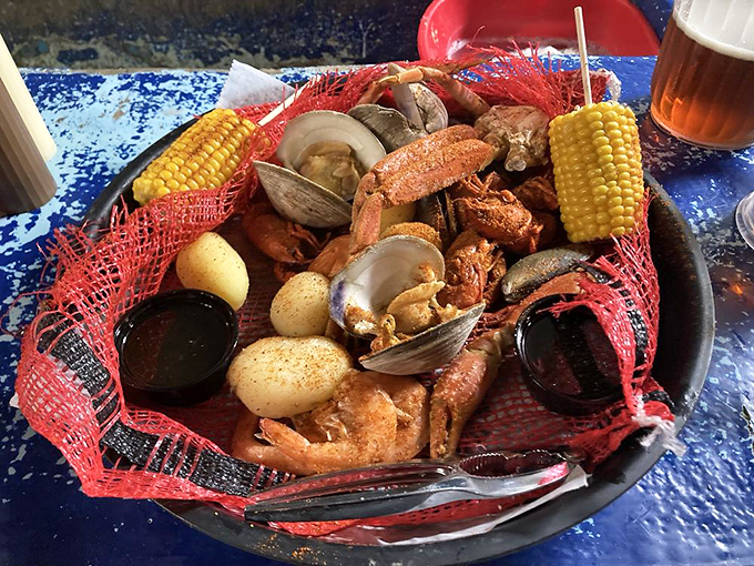 The seafood platter arrives like a fisherman's dream&mdash;clams, corn, potatoes, and shrimp nestled in a red net of deliciousness.