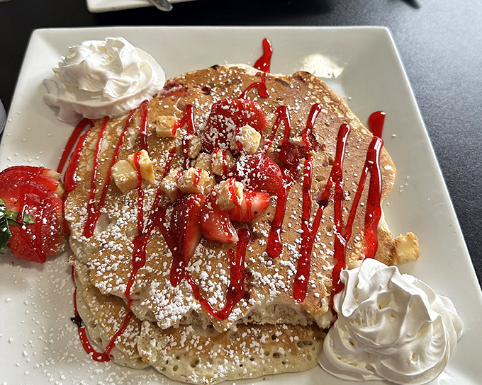 Pancakes wearing strawberries and whipped cream like they're dressed for the prom. Breakfast doesn't get more festive than this.