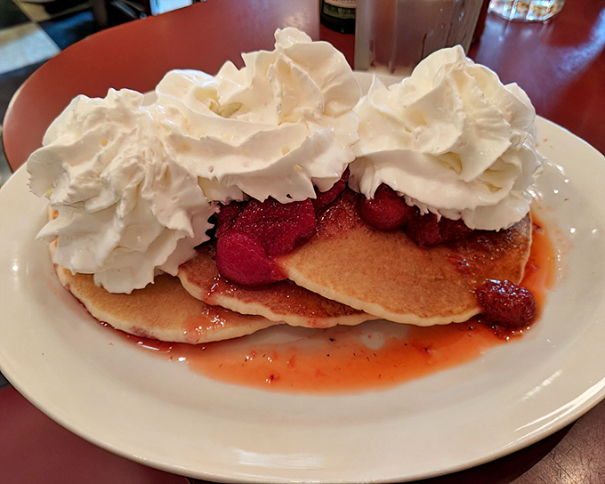 These strawberry pancakes aren't just breakfast, they're dessert with an alibi, crowned with whipped cream mountains that would make a pastry chef weep.