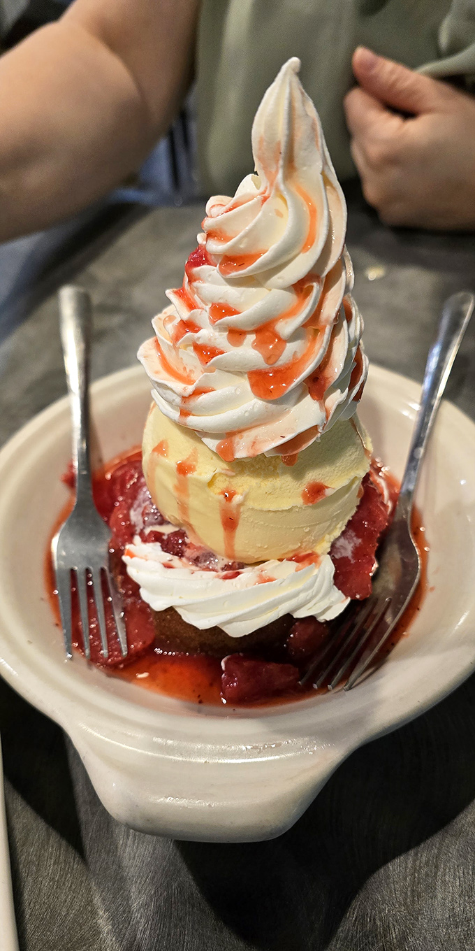 This isn't just dessert; it's architecture. A towering strawberry shortcake that makes you wonder if you should photograph it or devour it. (Spoiler: do both.) 