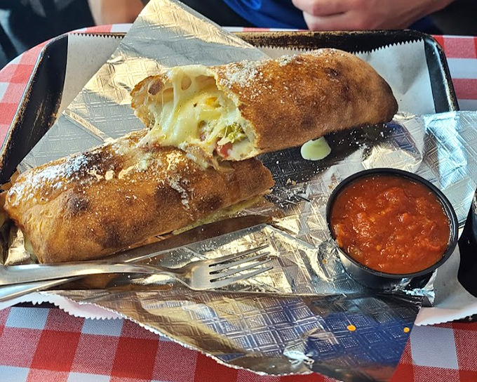 The stromboli here doesn't just stretch when you pull it apart &ndash; it performs an entire cheese ballet that deserves its own standing ovation. 