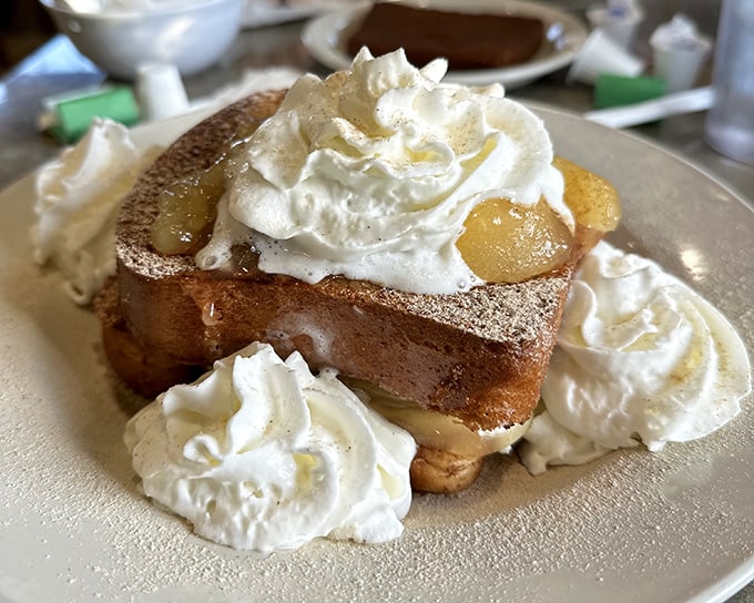 Stuffed French toast that makes ordinary breakfast feel like amateur hour. Those clouds of whipped cream aren't just garnish&mdash;they're essential supporting characters.