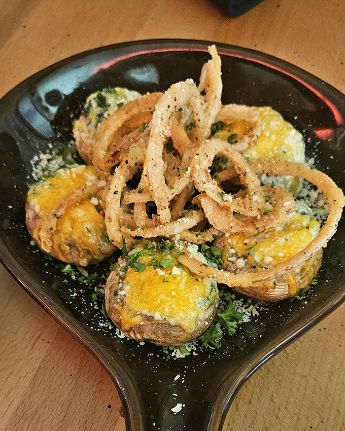 These stuffed mushrooms aren't just appetizers; they're little flavor bombs topped with crispy onion straws that would make even a vegetable skeptic weak at the knees.