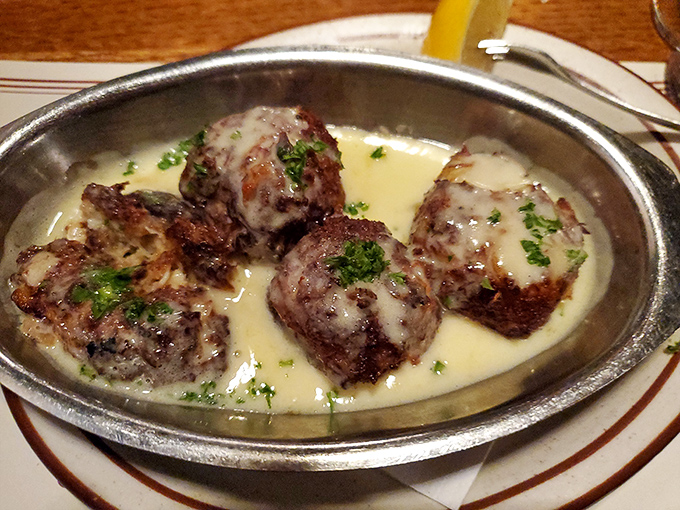 These stuffed mushrooms swim in a buttery sea of deliciousness, each bite offering a perfect balance of earth and ocean.