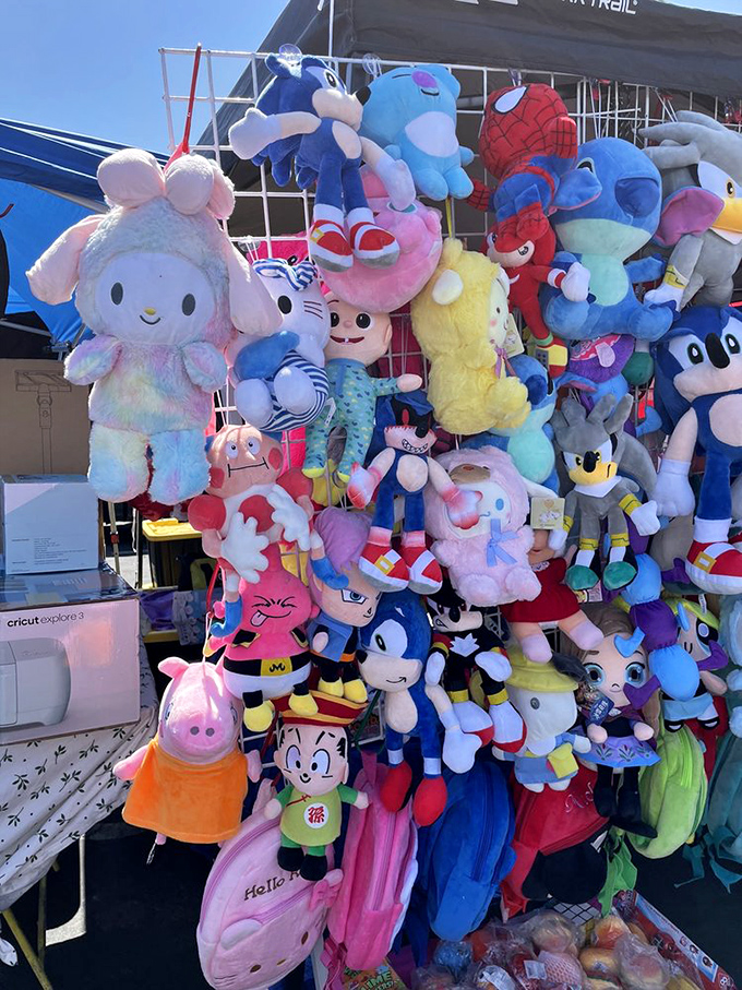 A mountain of plush pals waiting for new homes. Sonic, Pikachu, and friends create a colorful tower of nostalgia that's impossible to walk past.