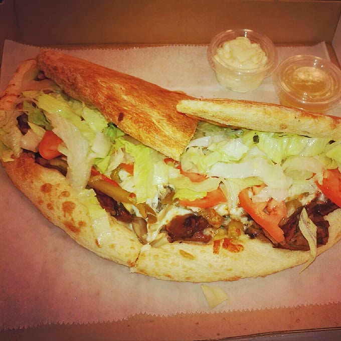 A proper Italian sub should require both hands and at least three napkins. This beauty, bursting with fresh veggies, clearly follows the rules.