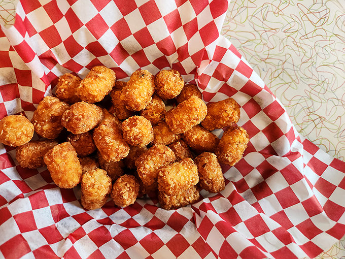 Golden-brown tater tots nestled in their checkered cradle&mdash;proof that sometimes the best things in life are simple, crispy, and dippable.