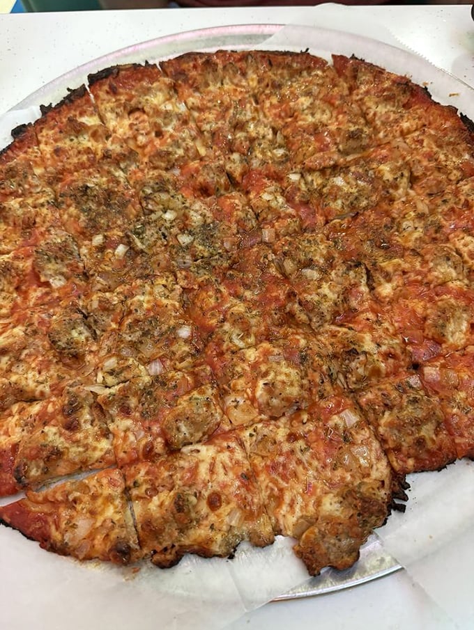 Behold the legendary tavern-style sausage pizza&mdash;thin enough to eat three slices but substantial enough to remember for years.