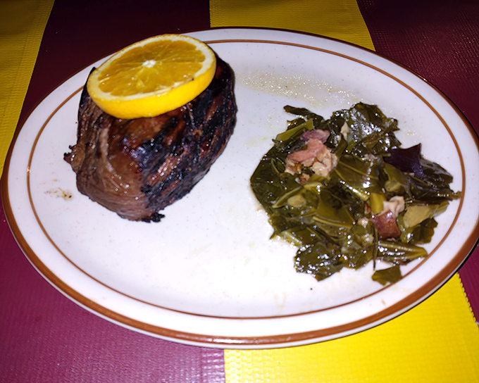 This teriyaki sirloin topped with a bright citrus slice sits alongside collard greens cooked Southern-style&mdash;proof that flavor trumps fanciness every time.