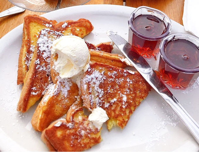 French toast that's had proper culinary training &ndash; crisp edges, custardy center, and powdered sugar that falls like delicious snow. The ice cream is just showing off.