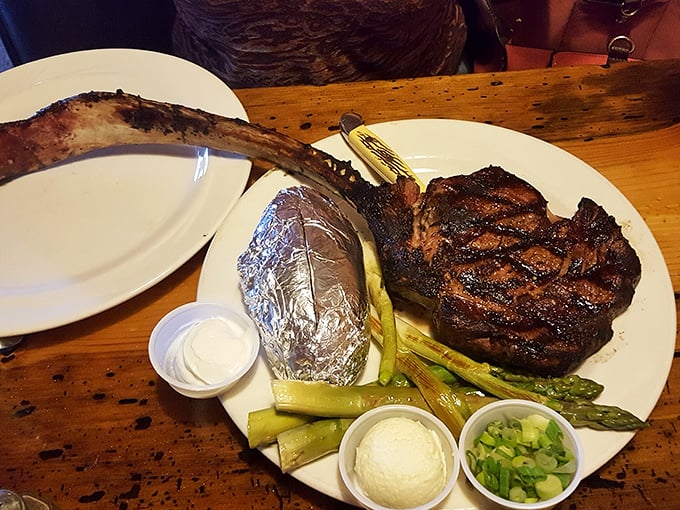 This isn't just a steak, it's a prehistoric declaration of carnivorous intent &ndash; complete with asparagus soldiers standing guard over buttery mashed potatoes.