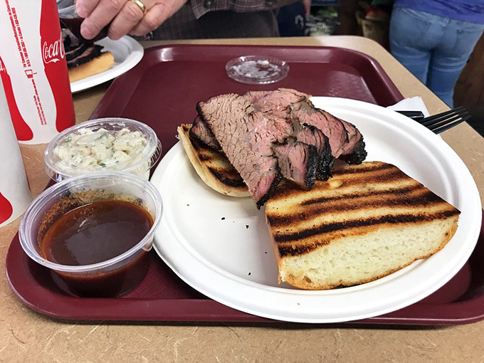 The star of the show: perfectly pink tri-tip on grilled bread, accompanied by coleslaw and sauce &ndash; a California dream that fits in two hands.