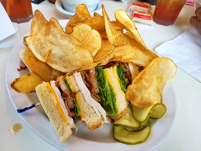 The club sandwich&mdash;architecture you can eat. Those homemade chips aren't just sides, they're supporting characters in this lunchtime drama.