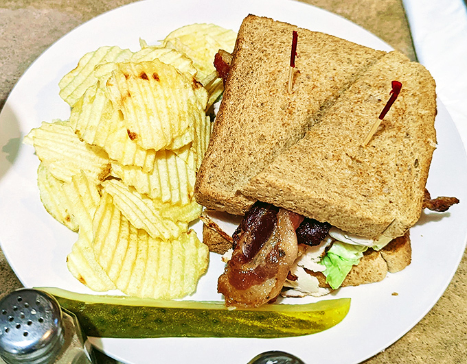 The club sandwich&mdash;architecture you can eat! Layers of turkey and bacon between toast triangles, with chips standing guard like crunchy sentinels.