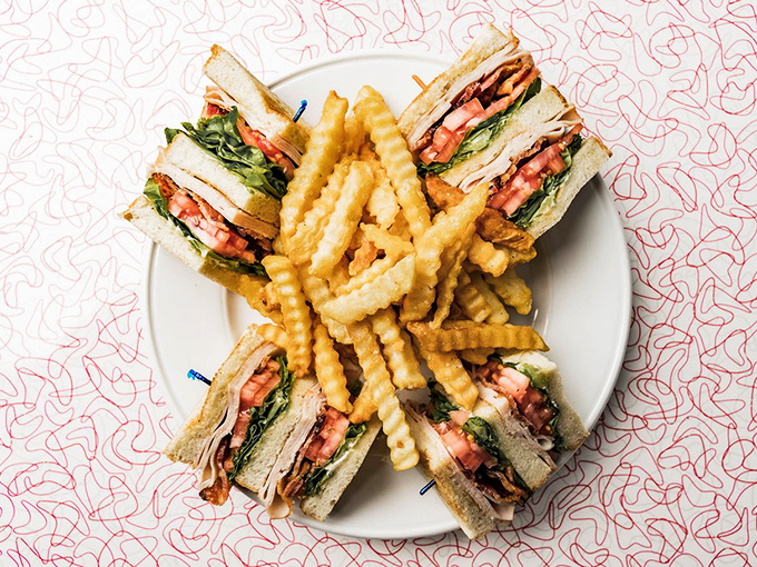 This isn't just a sandwich&mdash;it's architecture. The Turkey Club stands tall like Delaware's own edible skyscraper, complete with bacon buttresses.