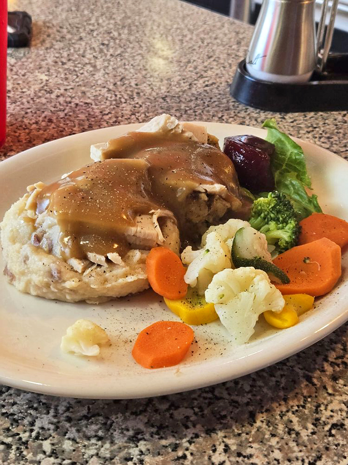 Comfort on a plate: tender turkey smothered in gravy alongside perfectly seasoned vegetables that even vegetable-avoiders might actually finish.