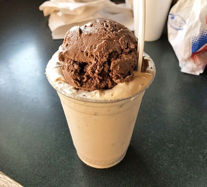 This isn't just a milkshake; it's a structural engineering marvel with chocolate ice cream defying gravity atop a creamy foundation.