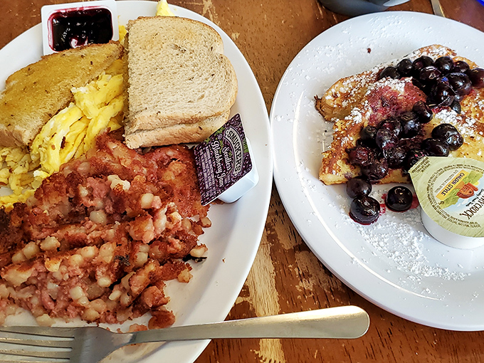 The holy trinity of breakfast perfection: crispy corned beef hash, fluffy scrambled eggs, and toast ready for that essential butter-to-bread ratio.