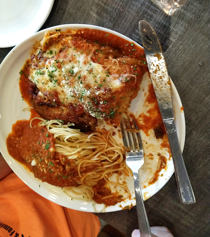 Half-eaten veal parmigiana with spaghetti&mdash;the universal sign that something was too good to wait for a photo before diving in.
