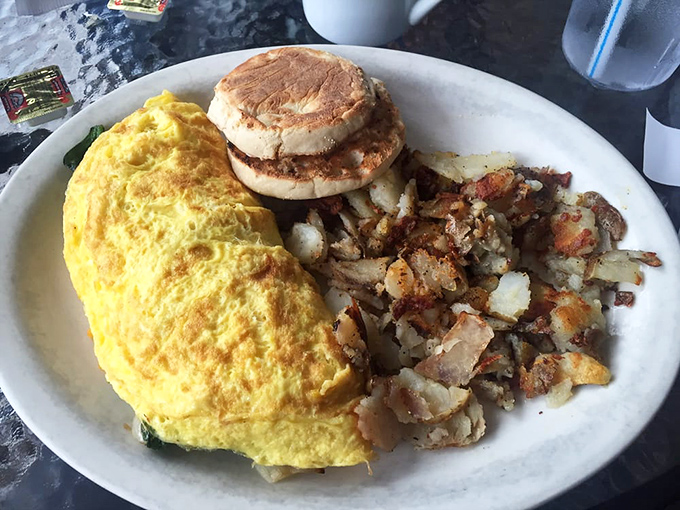 Sunshine on a plate! This omelet practically glows with eggy perfection, while the English muffin stands by, ready for its supporting role.