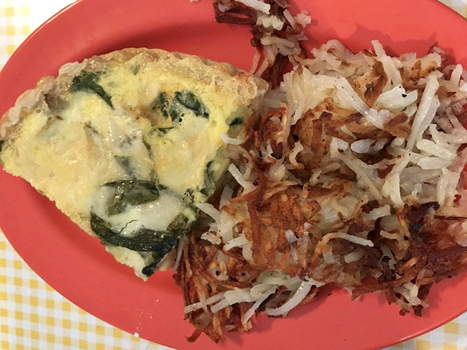 This veggie-packed creation sits proudly on its coral plate, like breakfast royalty with a golden hash brown crown.