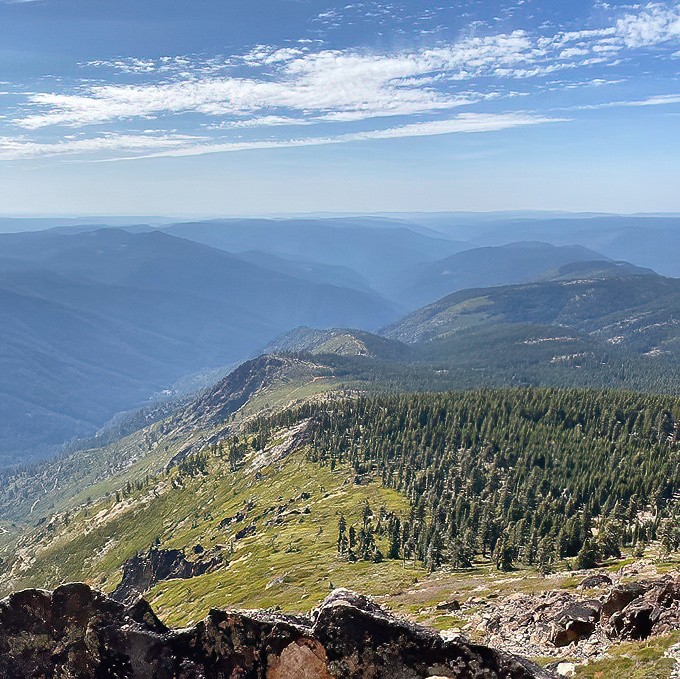 The reward for huffing up Sierra Buttes trails? This layered landscape of blue-tinged mountains that makes your Instagram followers think you've mastered Photoshop.