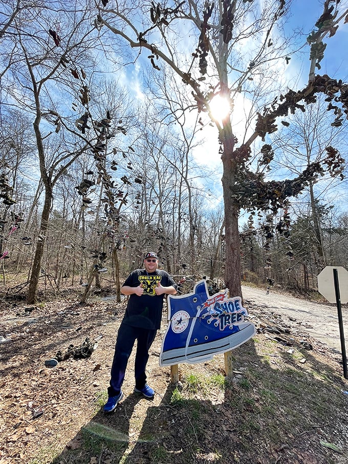 The official Shoe Tree sign welcomes curious travelers, promising a world-famous oddity that absolutely delivers on its strange promise.