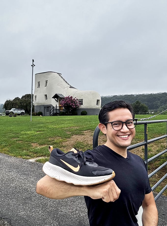 The ultimate photo op &ndash; bringing your own shoe to pose with the Shoe House. This visitor clearly understands the assignment.