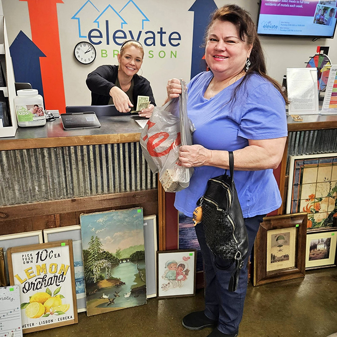 The moment of triumph at the checkout counter. That smile says, "I just found designer items for less than a fancy coffee, and yes, I'm feeling smug about it."
