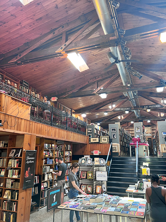 The exposed wooden beams overhead aren't just architectural features—they're the ribcage of this literary beast that's swallowed thousands of volumes whole.